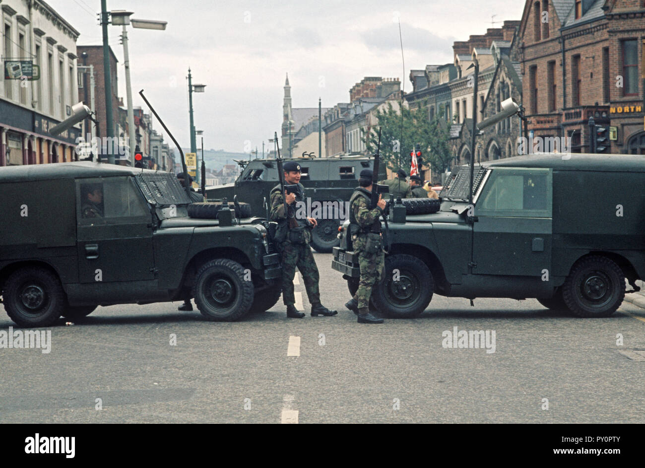 Belfast, 1972: British Army Land Rovers and soldiers blocking road in ...
