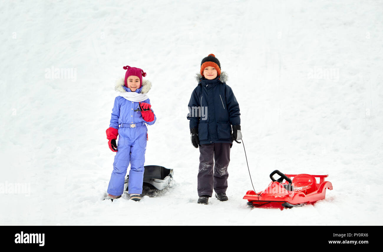 happy little kids with sleds in winter Stock Photo - Alamy