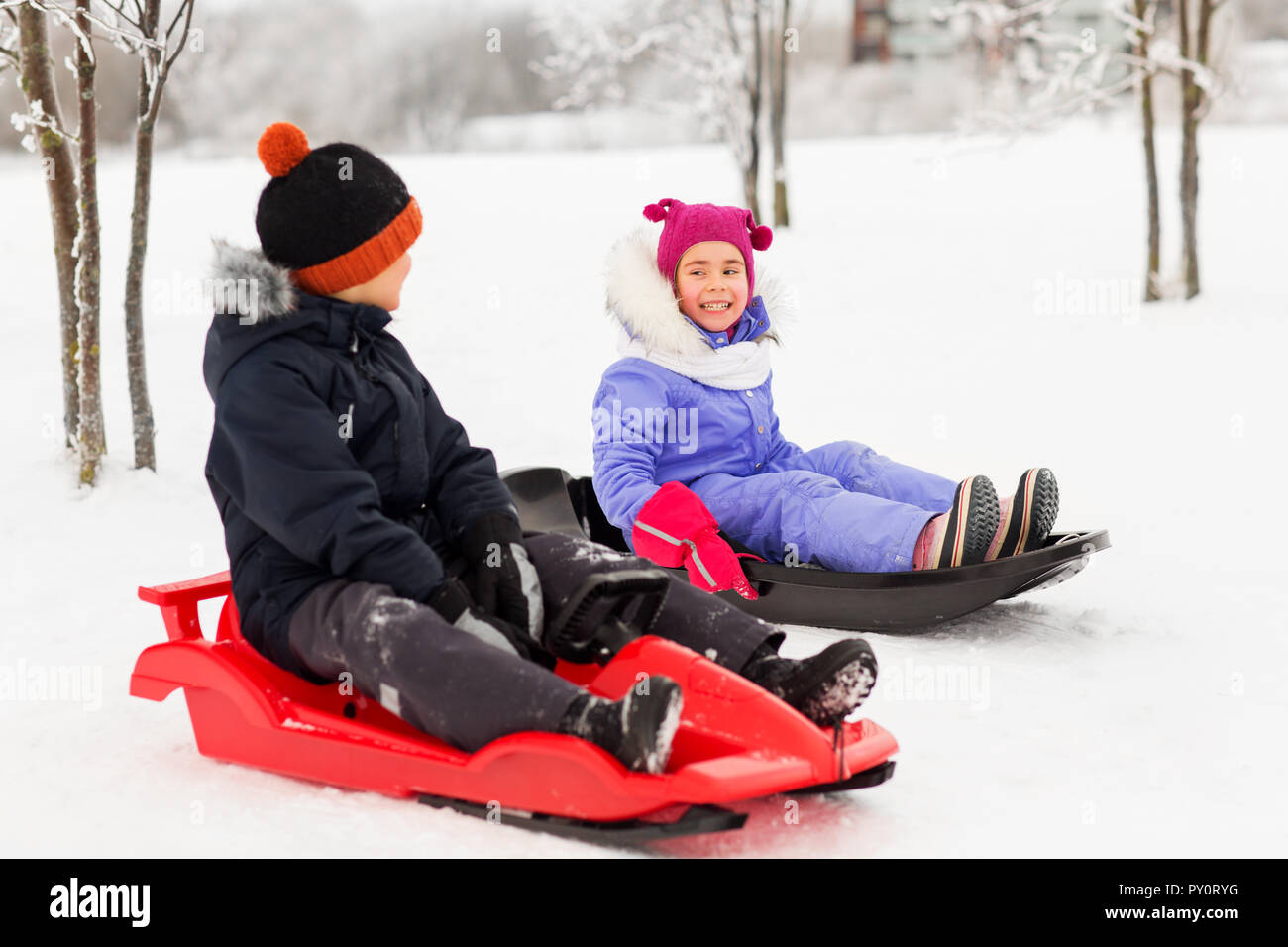 happy little kids sliding on sleds in winter Stock Photo - Alamy