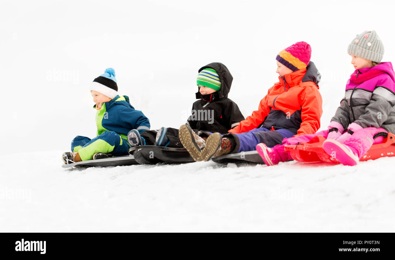 happy little kids sliding on sleds in winter Stock Photo - Alamy