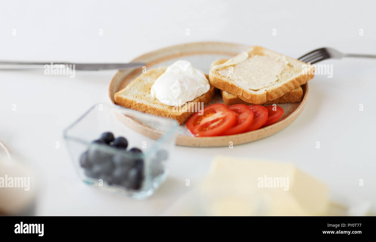 toasts with poached egg and vegetables on plate Stock Photo - Alamy