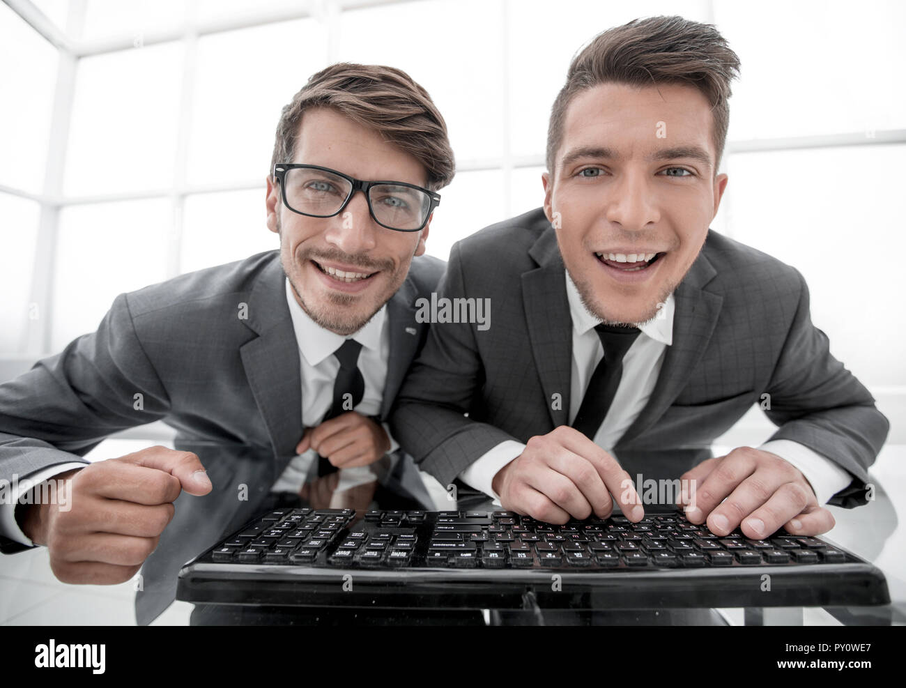 businessmen are looking directly into the camera while sitting i Stock ...