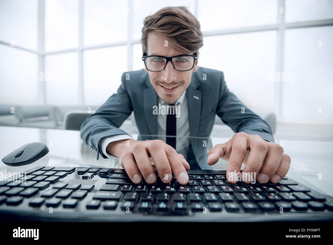 young man using keyboard , closely and carefully looking at the Stock ...