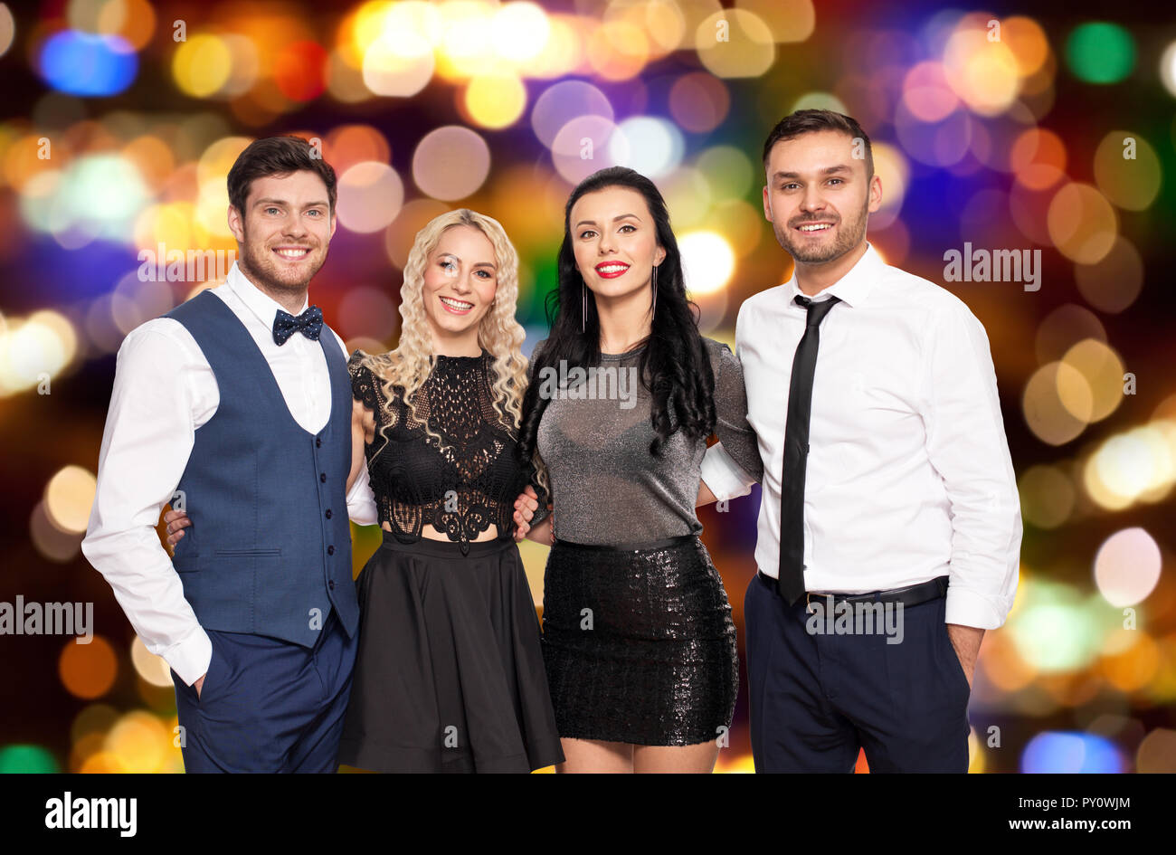 happy friends in party clothes hugging Stock Photo - Alamy