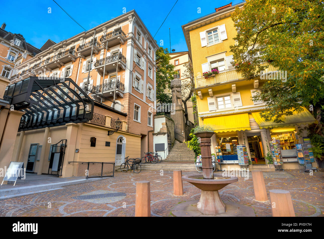 Cityscape with natural spring fountain and historic monument at centre ...