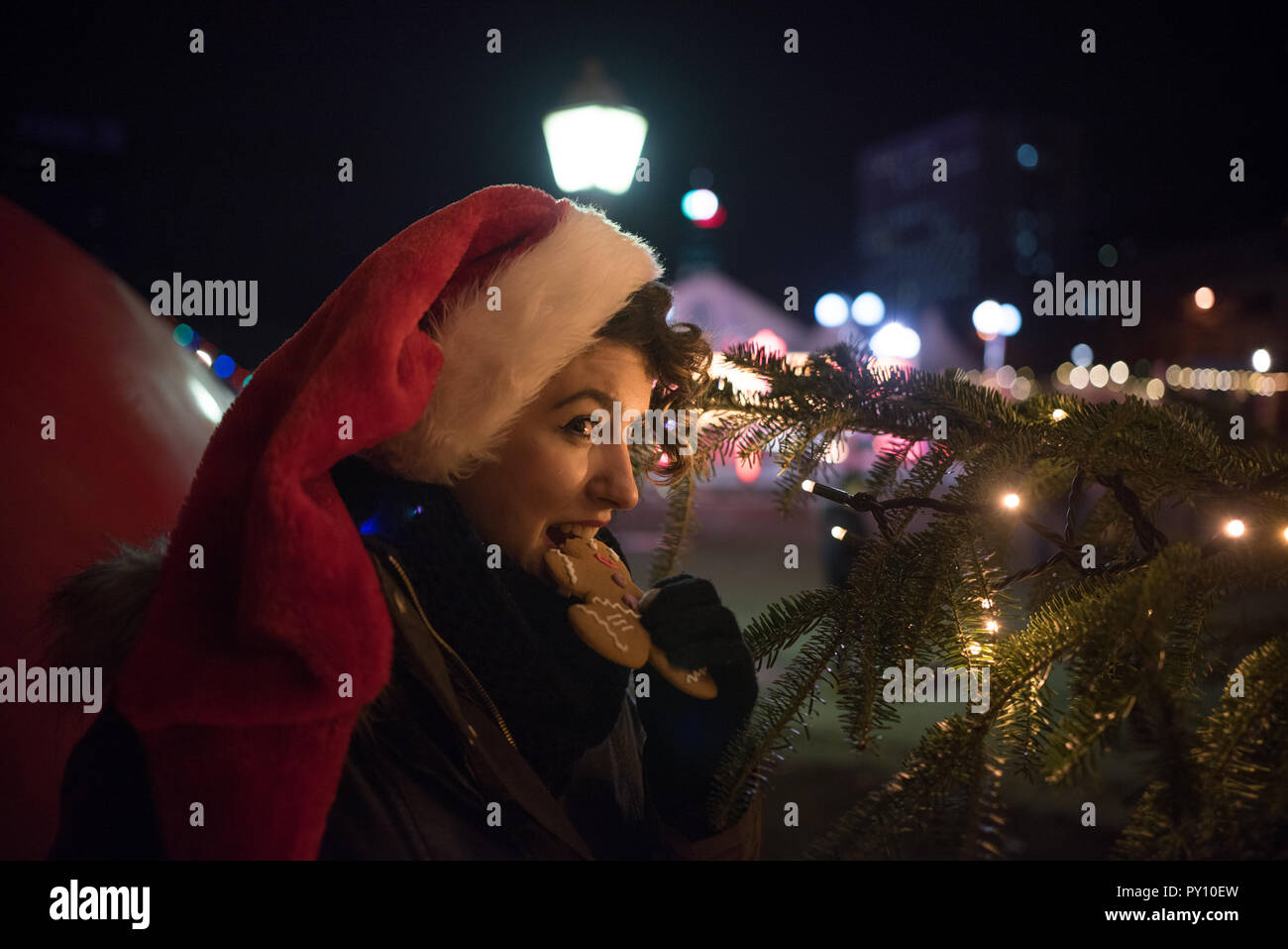 Woman eating gingerbread man hi-res stock photography and images - Alamy