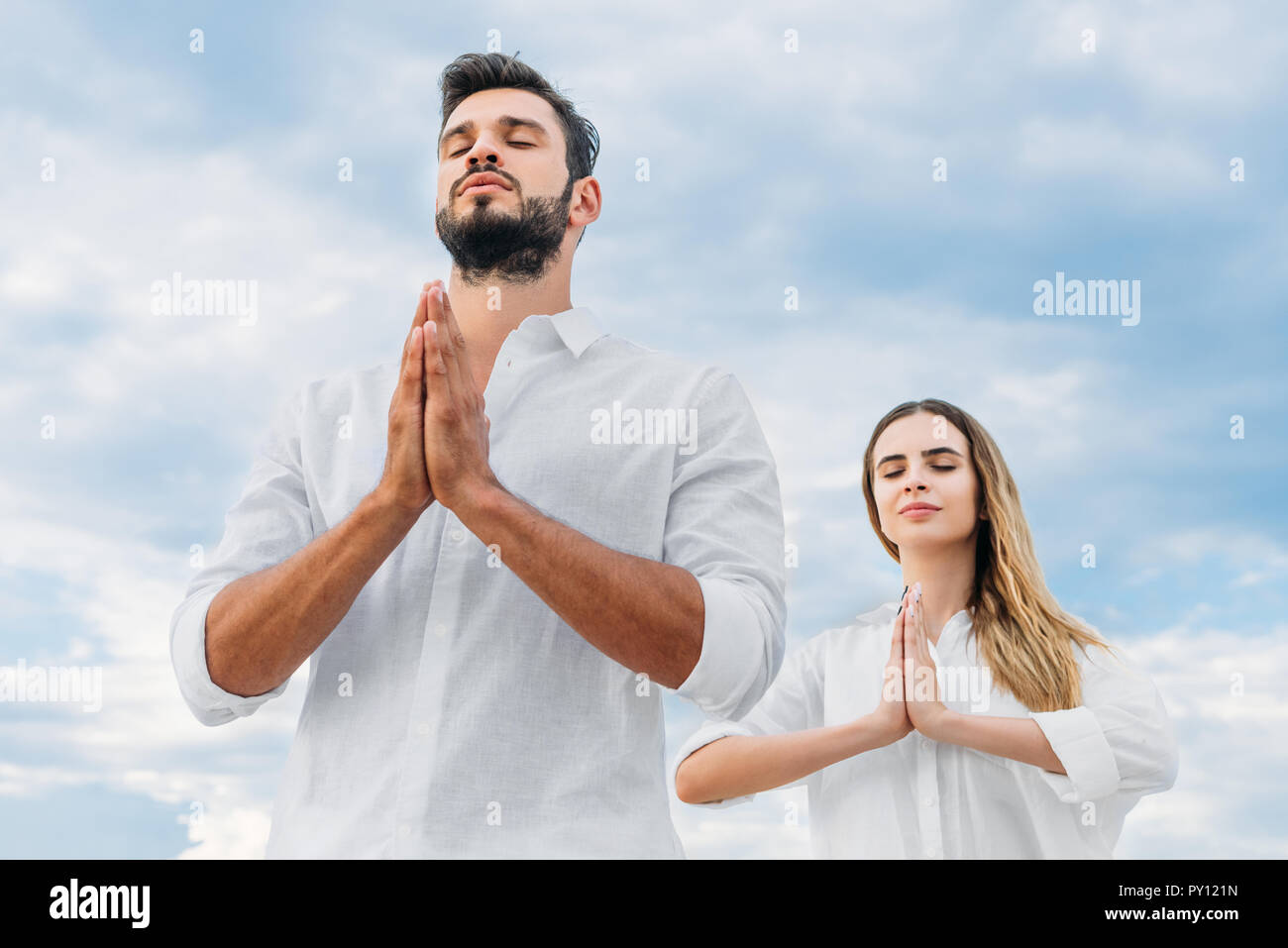 Couple meditating namaste hi-res stock photography and images - Alamy
