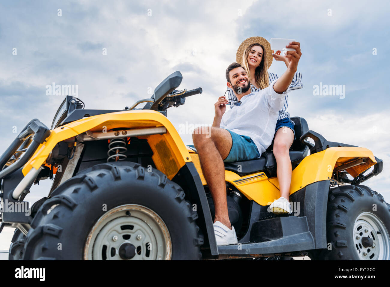 Young couple sitting on quad hi-res stock photography and images - Alamy