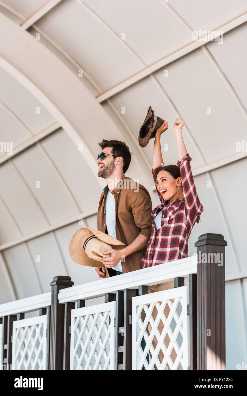 excited cowboy and cowgirl watching horse races at ranch stadium Stock ...