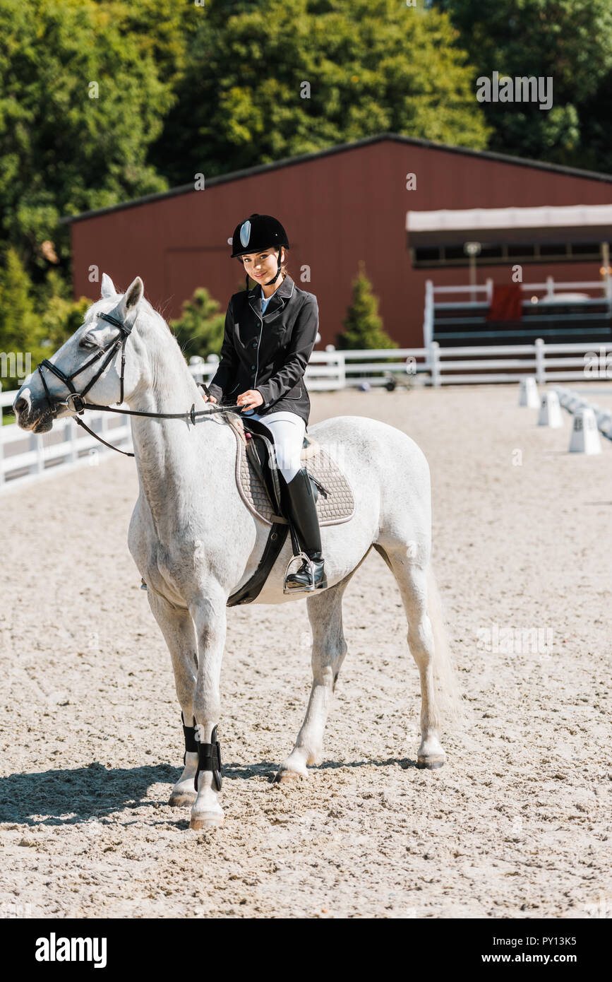 beautiful female equestrian riding horse at horse club Stock Photo - Alamy