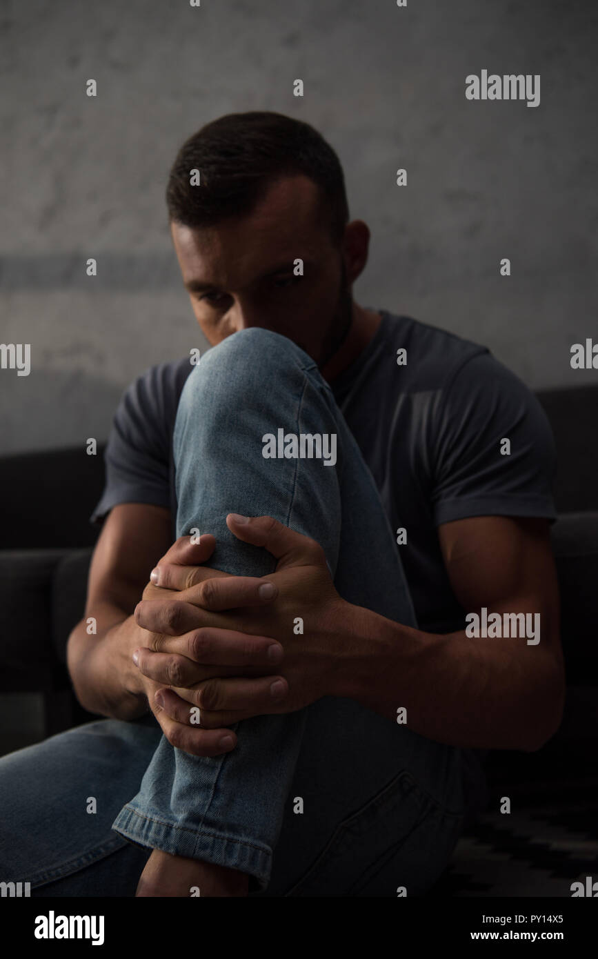 Upset depressed man sitting hi-res stock photography and images - Alamy