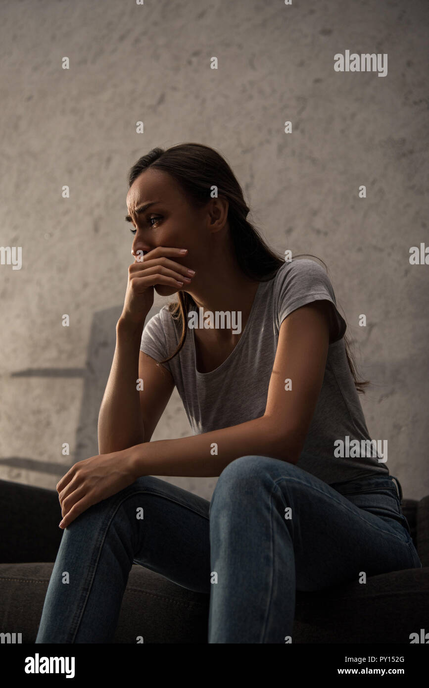 Lonely girl sitting on sofa hi-res stock photography and images - Alamy