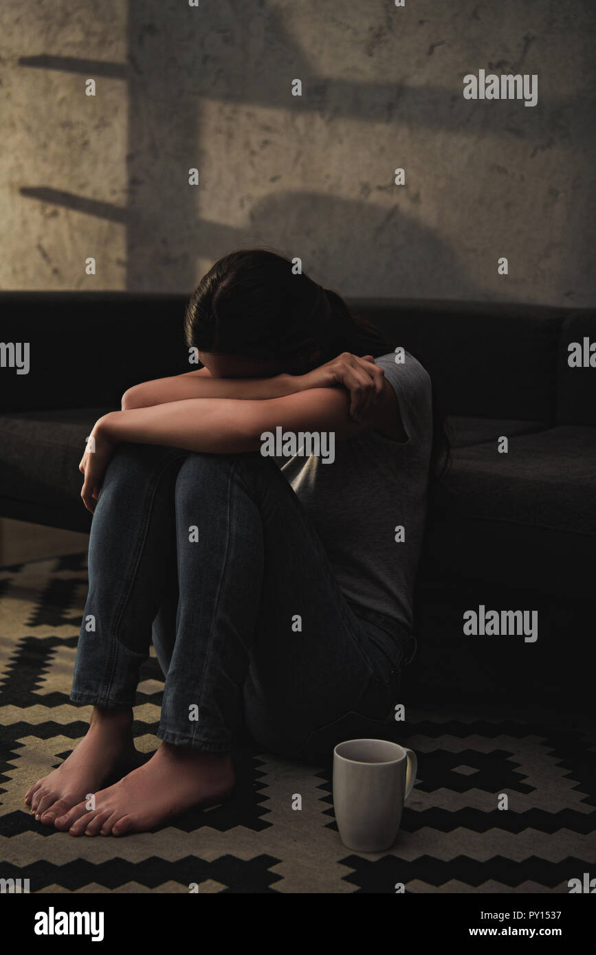 Girl sitting on sofa knees hi-res stock photography and images - Alamy