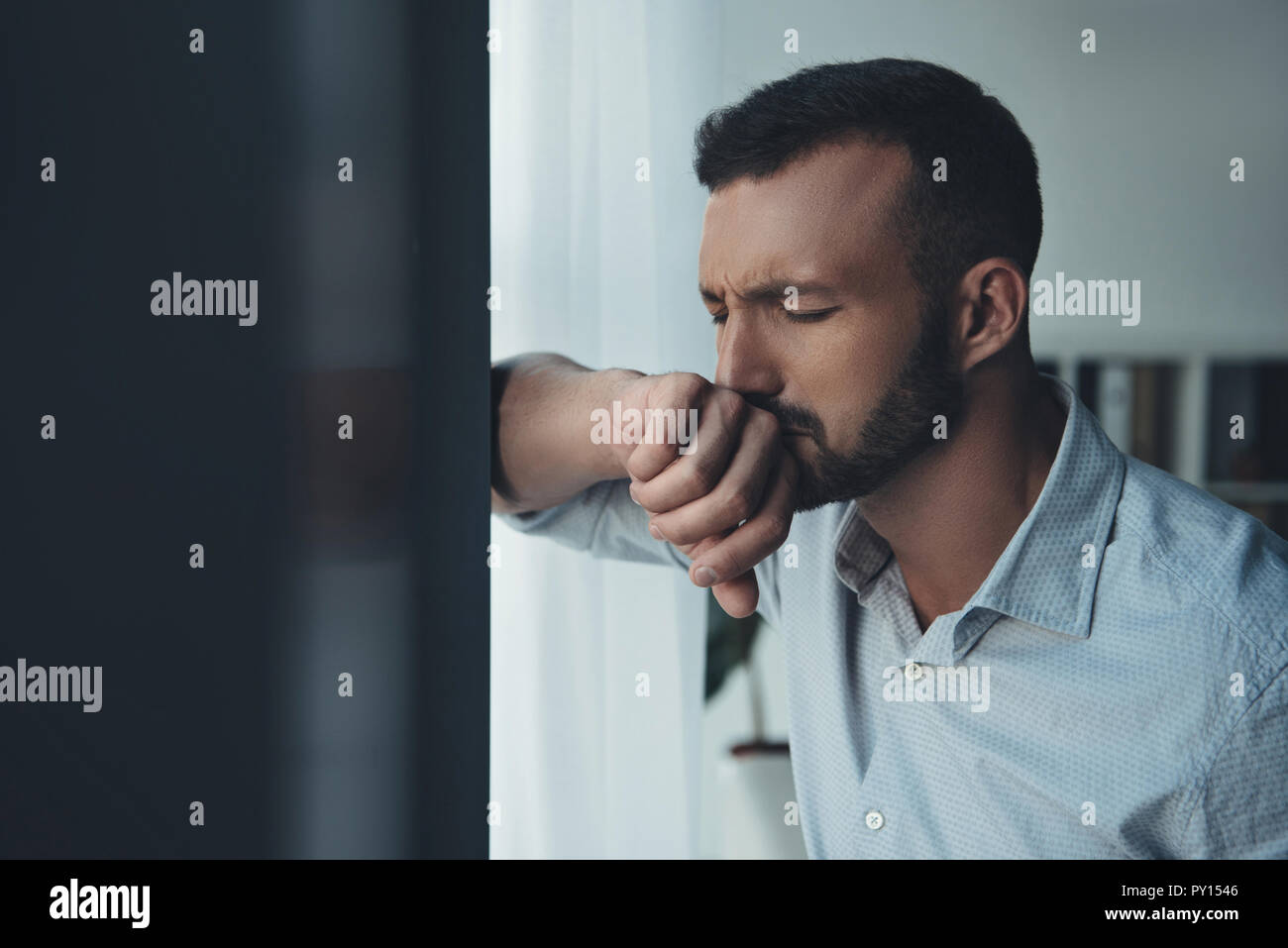 lonely sad handsome man standing near window at home Stock Photo - Alamy