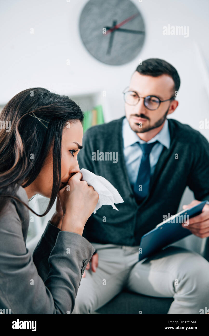 sad patient crying in psychologist office Stock Photo - Alamy