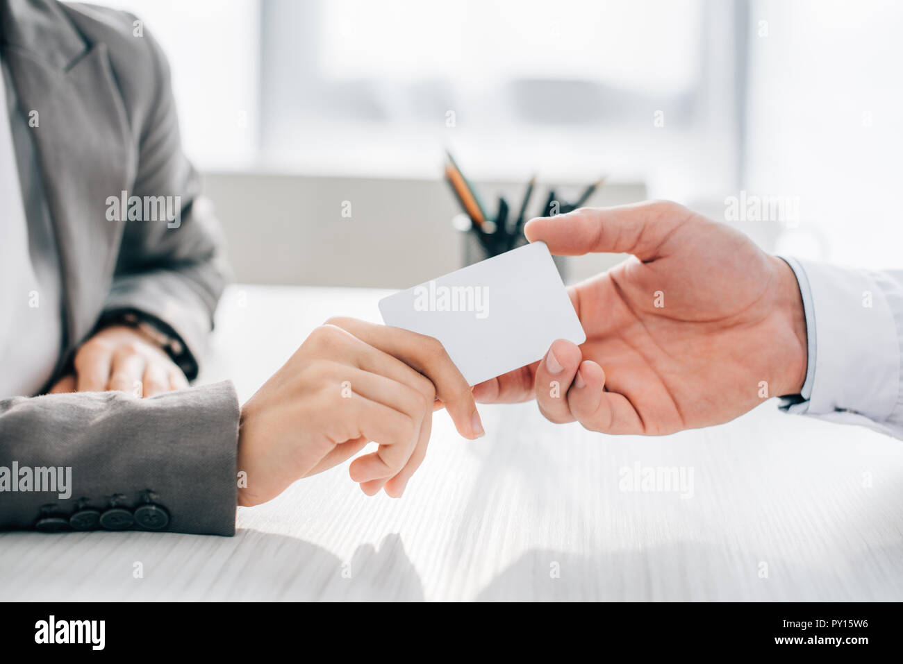 cropped image of patient giving id card to doctor in clinic Stock Photo ...