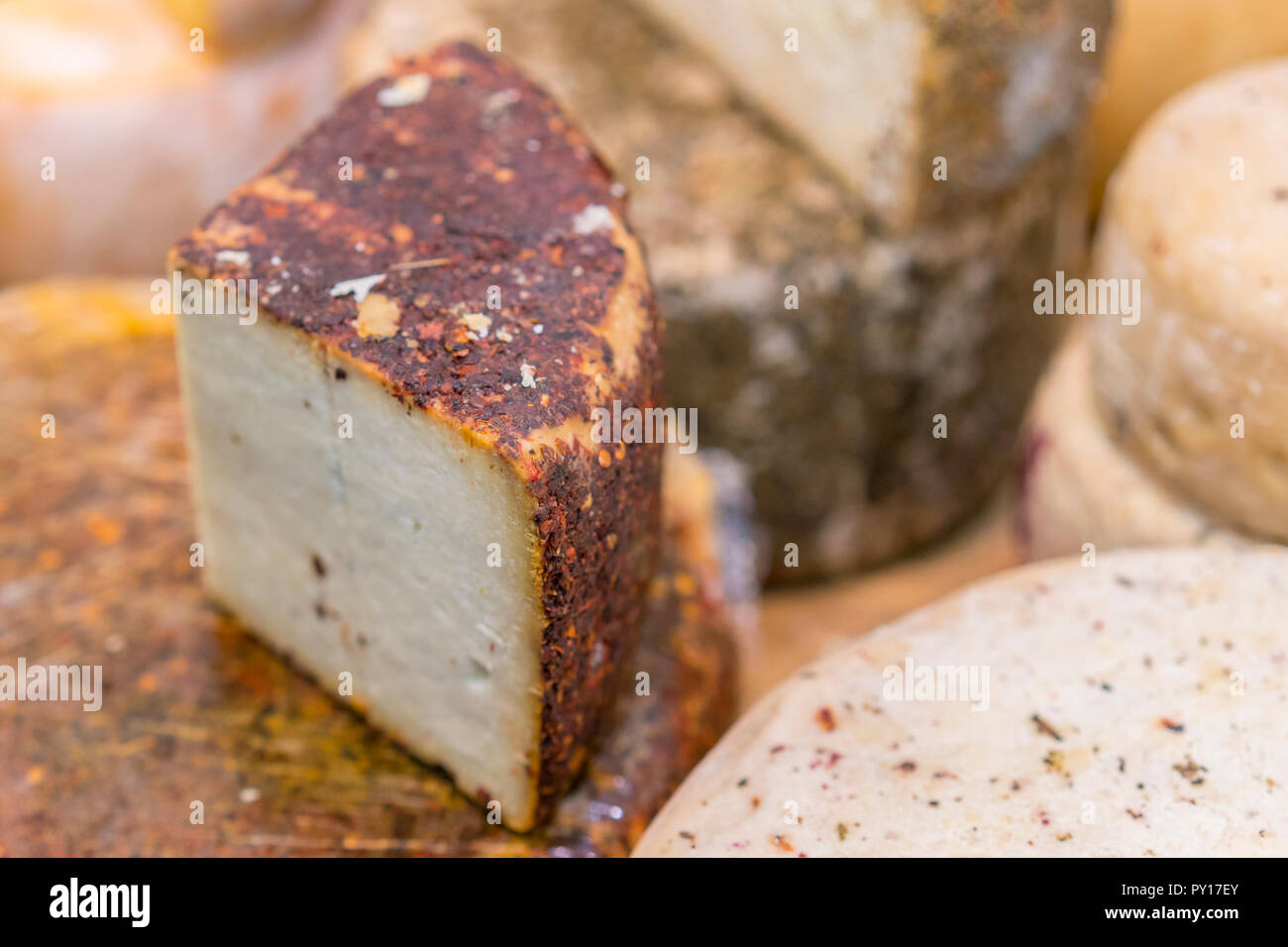 Craft cheese. Cheese head. Artisan cheese Stock Photo - Alamy