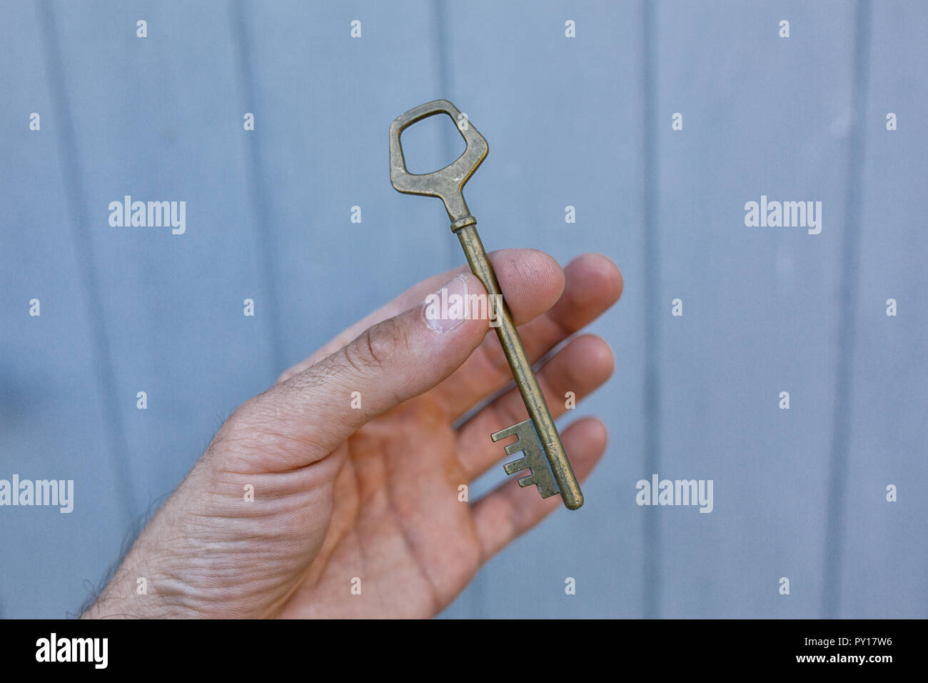 Antique key in hand hi-res stock photography and images - Alamy