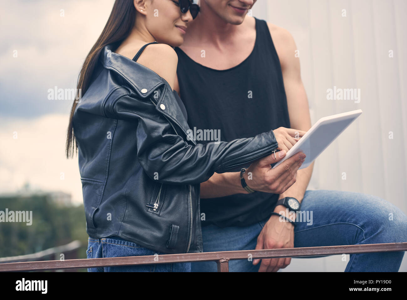 cropped view of young couple using digital device together Stock Photo ...