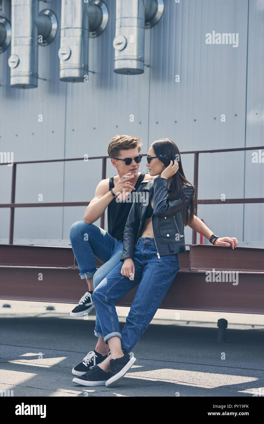 stylish multicultural couple smoking cigarette together Stock Photo - Alamy