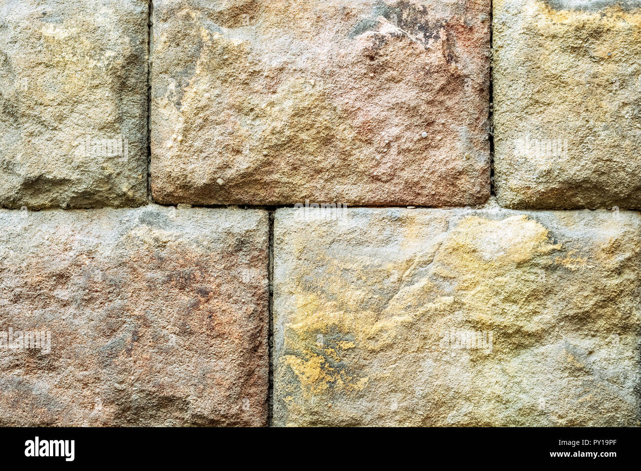 Wall of variegated stone blocks for use as a background Stock Photo - Alamy