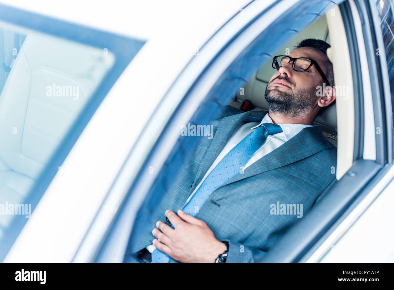 Handsome man sleeping in car hi-res stock photography and images - Alamy