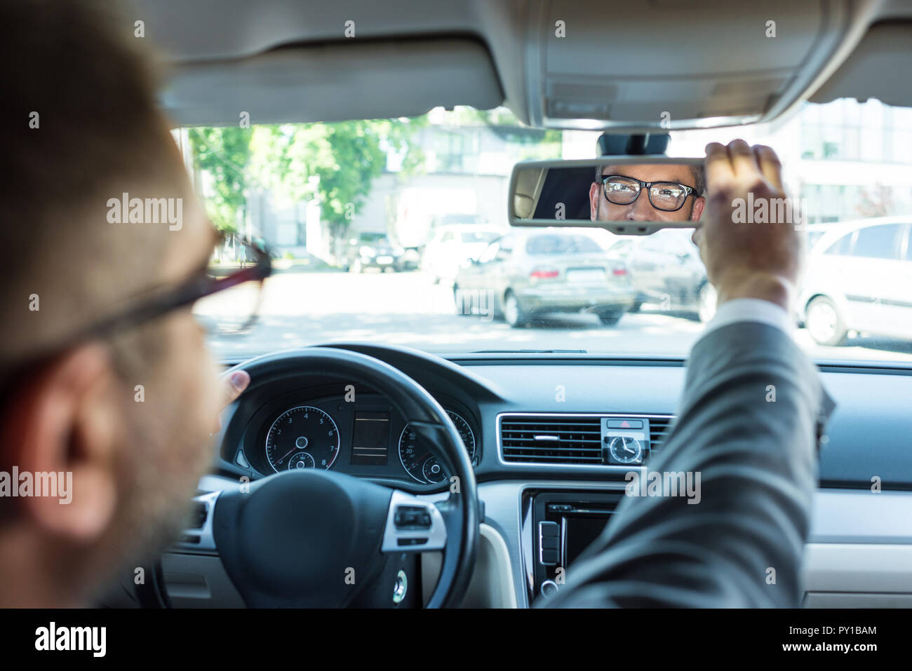 Man looking rear view mirror in car hi-res stock photography and images ...