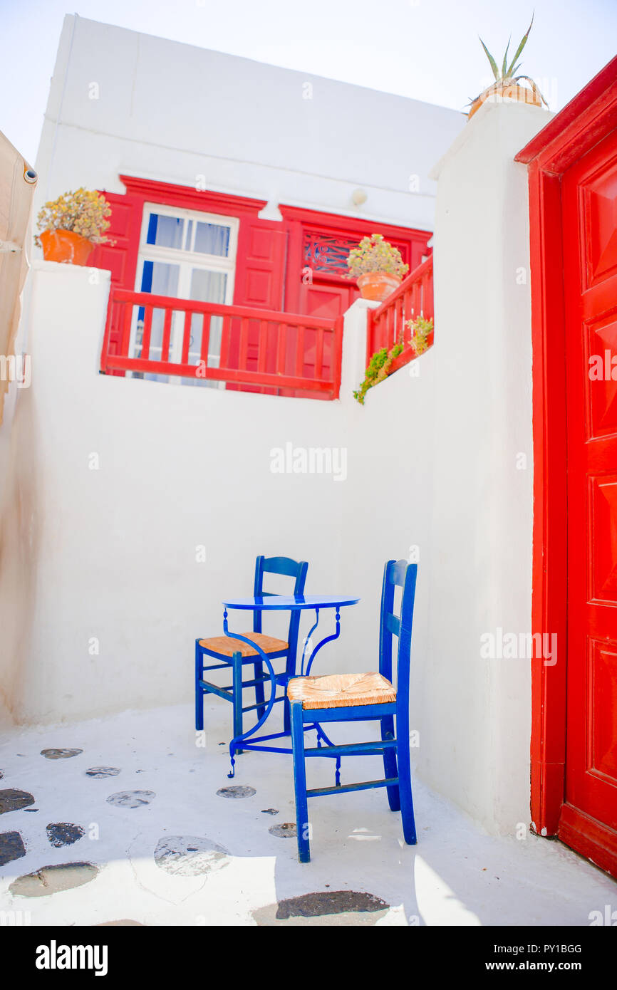 Cute cafe on the street of typical greek traditional village on Mykonos ...