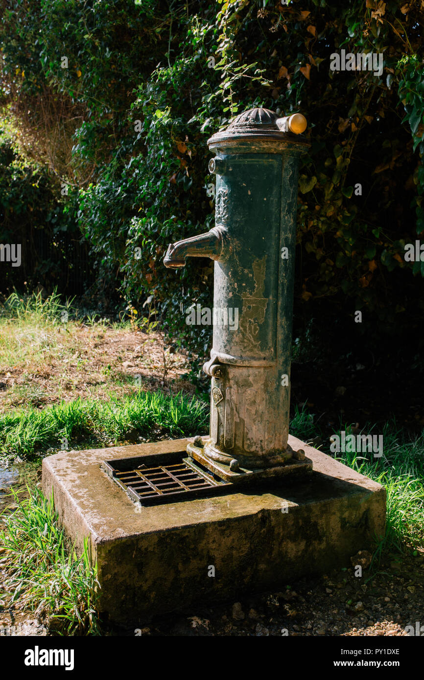 Water column in the street with concrete base and flowing water Stock ...
