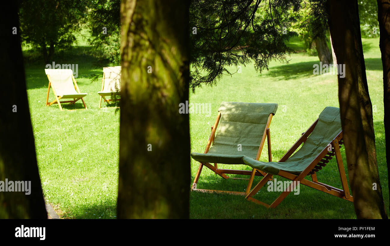 Rest chairs in the garden. Resort concept Stock Photo - Alamy