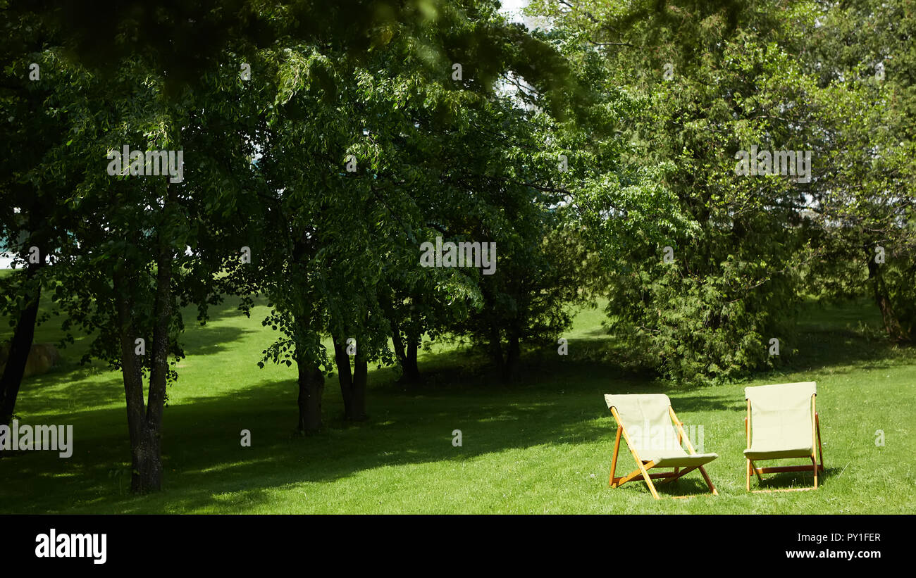 Rest chairs in the garden. Resort concept Stock Photo - Alamy