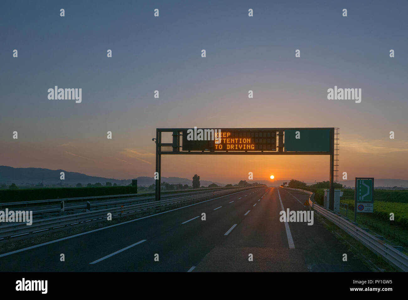Keep attention to driving written on highway road sign Stock Photo - Alamy