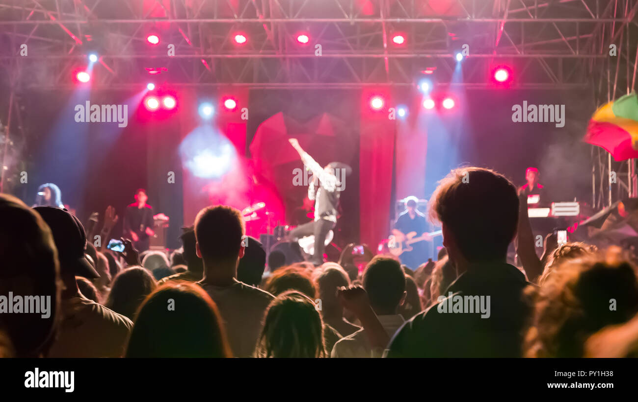 Cheering concert audience looking at vocalist on stage Stock Photo - Alamy