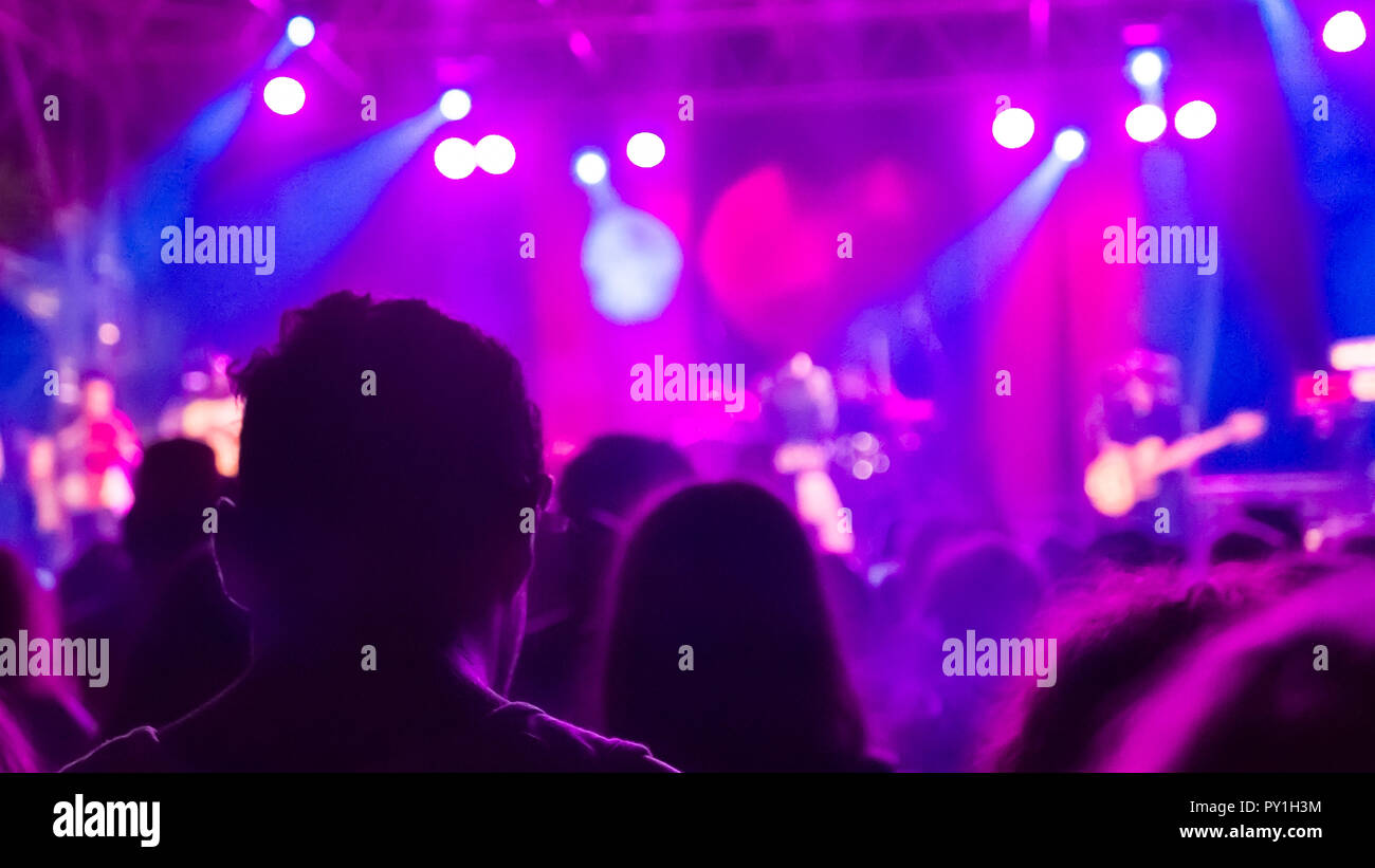 Calm man in the concert crowd listening to the music Stock Photo - Alamy