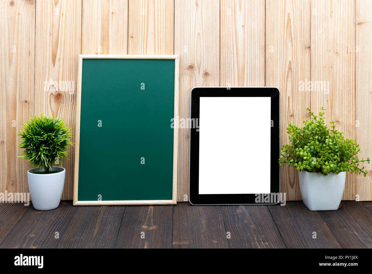 Blank green chalkboard or chalk board and tablet pc on wooden table ...
