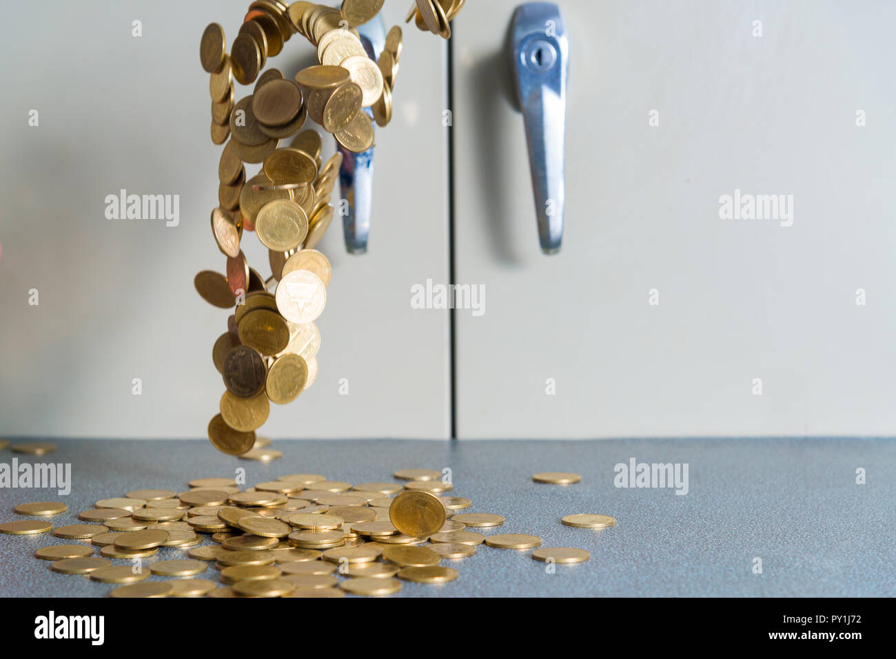 Falling gold coins money on office table with document cabinet ...