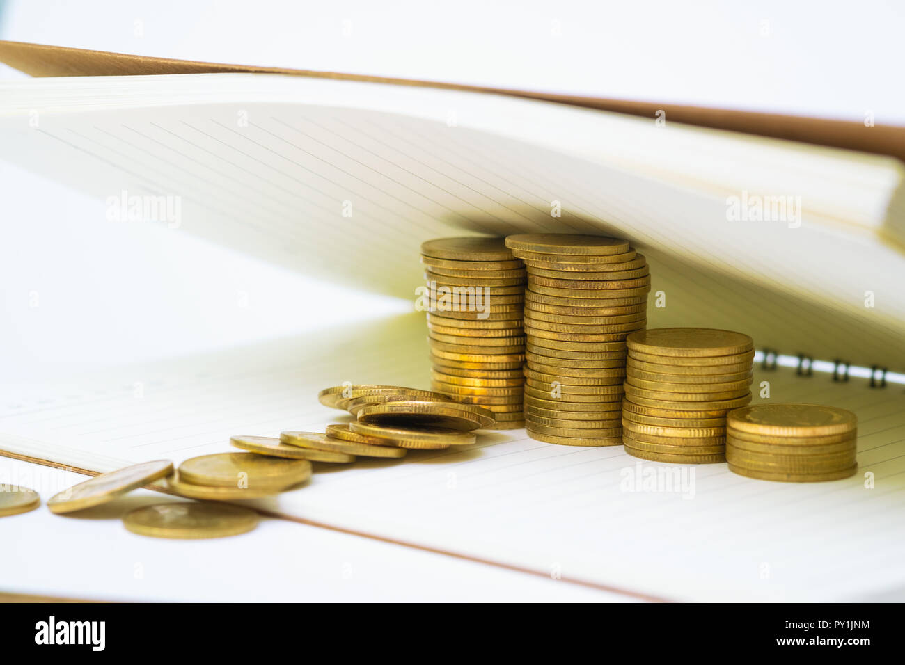 Step of coins stack on notebook paper with copy space for add text ...