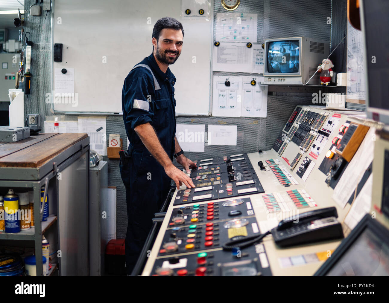 Marine engineer officer working in engine room Stock Photo - Alamy