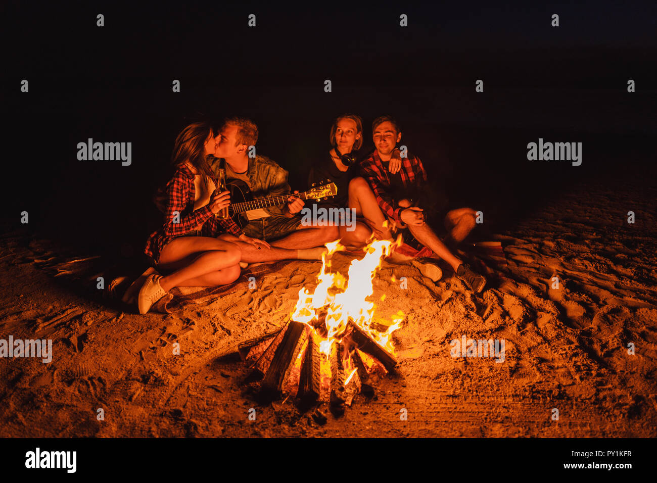 young friends have picnic with bonfire on the beach Stock Photo - Alamy