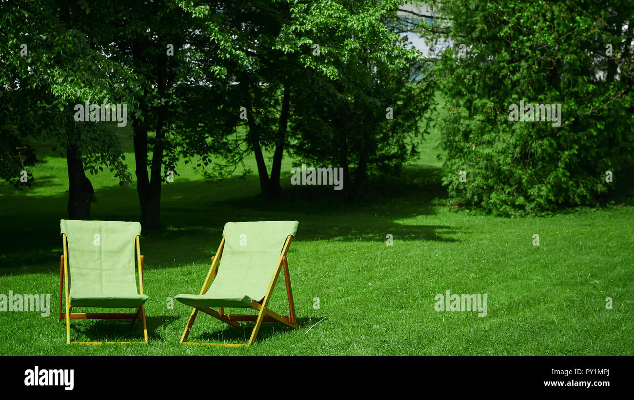 Two resting chairs in the city park Stock Photo - Alamy
