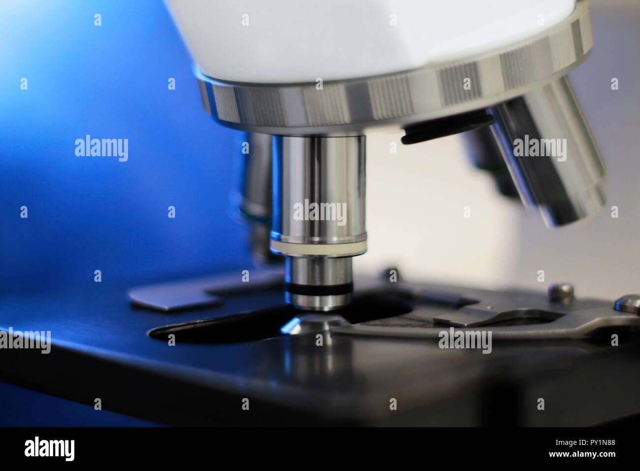 Microscope with blue background Stock Photo - Alamy