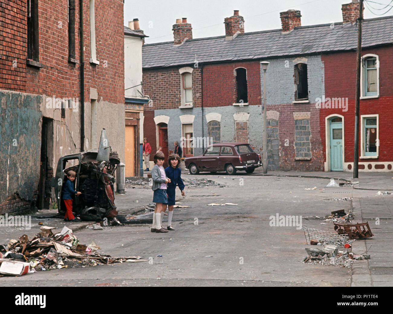 Belfast, 1972: Children playing in desolate street with houses meant ...