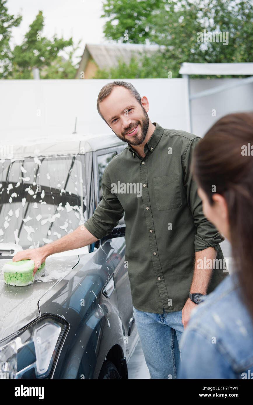 Young couple washing car together hi-res stock photography and images ...