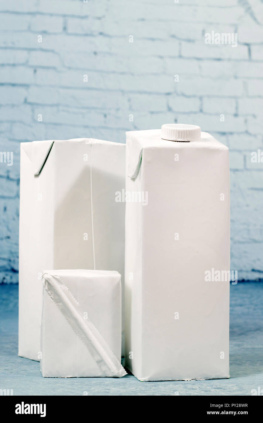 Mix of milk packages isolated on a blue brick background Stock Photo ...