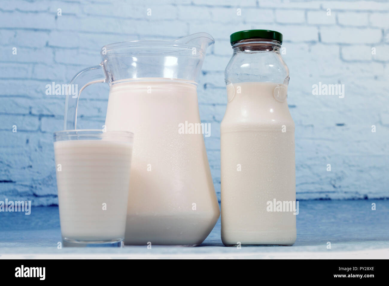 Mix of milk containers isolated on a blue brick background Stock Photo ...