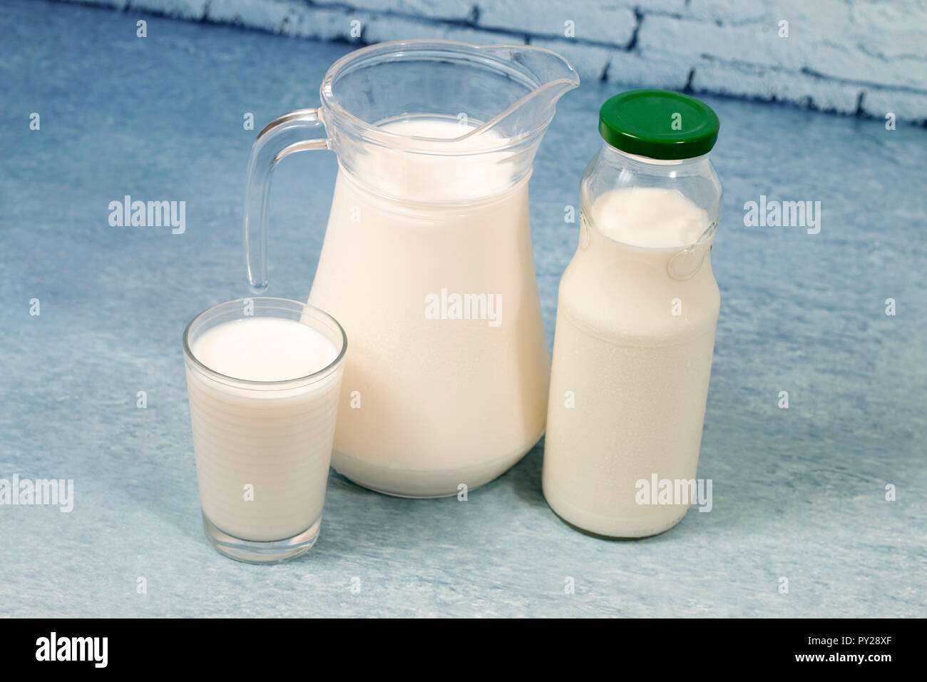Mix of milk containers isolated on a blue brick background Stock Photo ...
