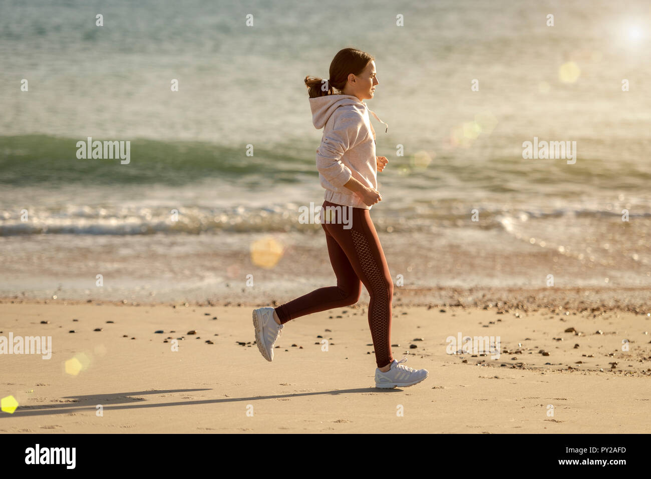 Woman jog beach hi-res stock photography and images - Alamy