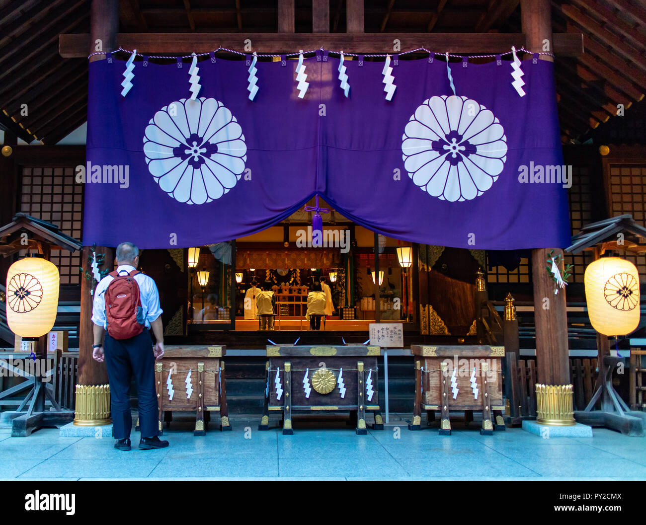 Tokyo, Japan - 10/13/2016: A man praying at a Shinto Shrine in Tokyo ...