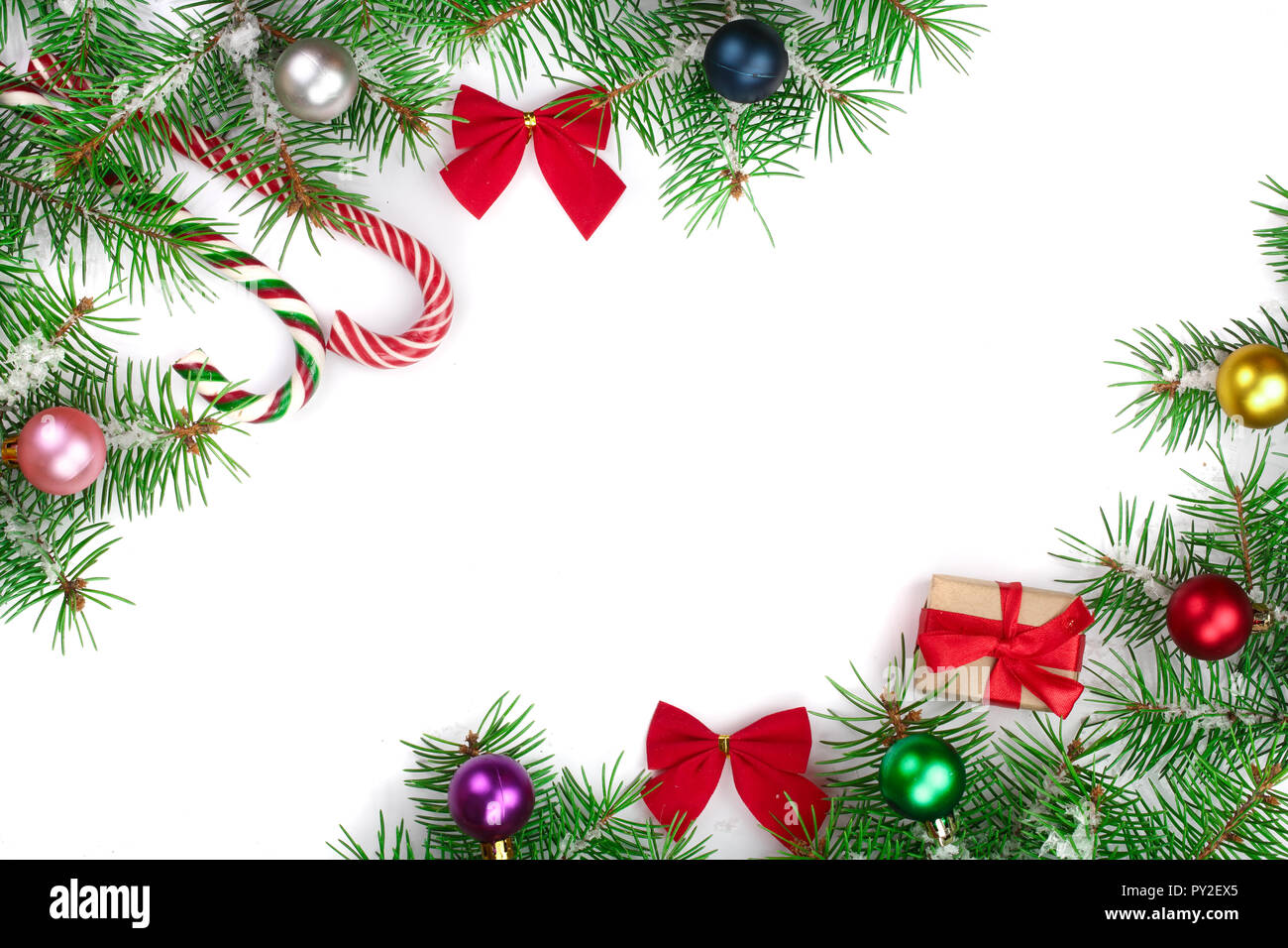 Christmas Frame of Fir tree branch with candy canes and snow isolated ...