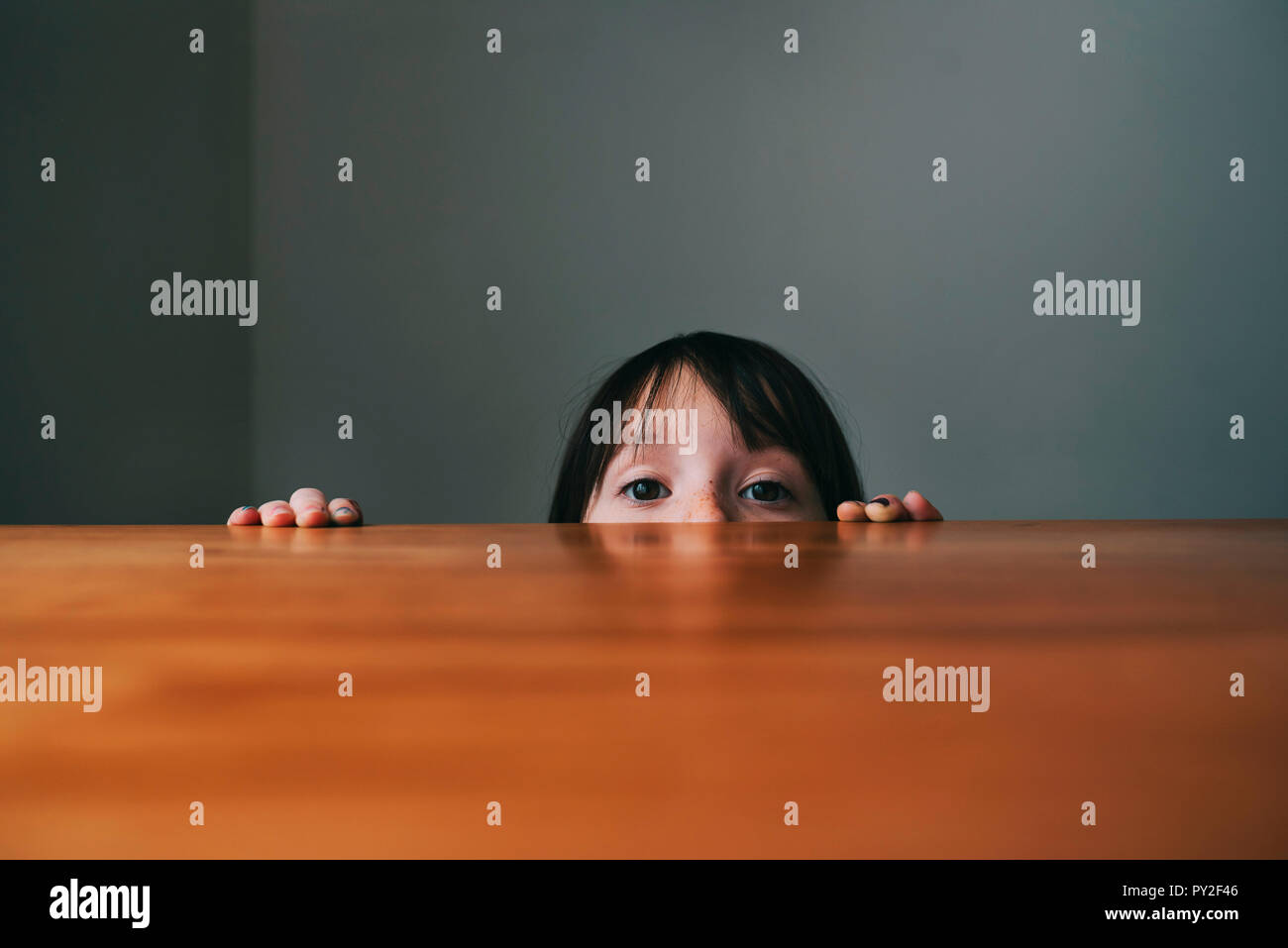 Girl standing behind table hi-res stock photography and images - Alamy